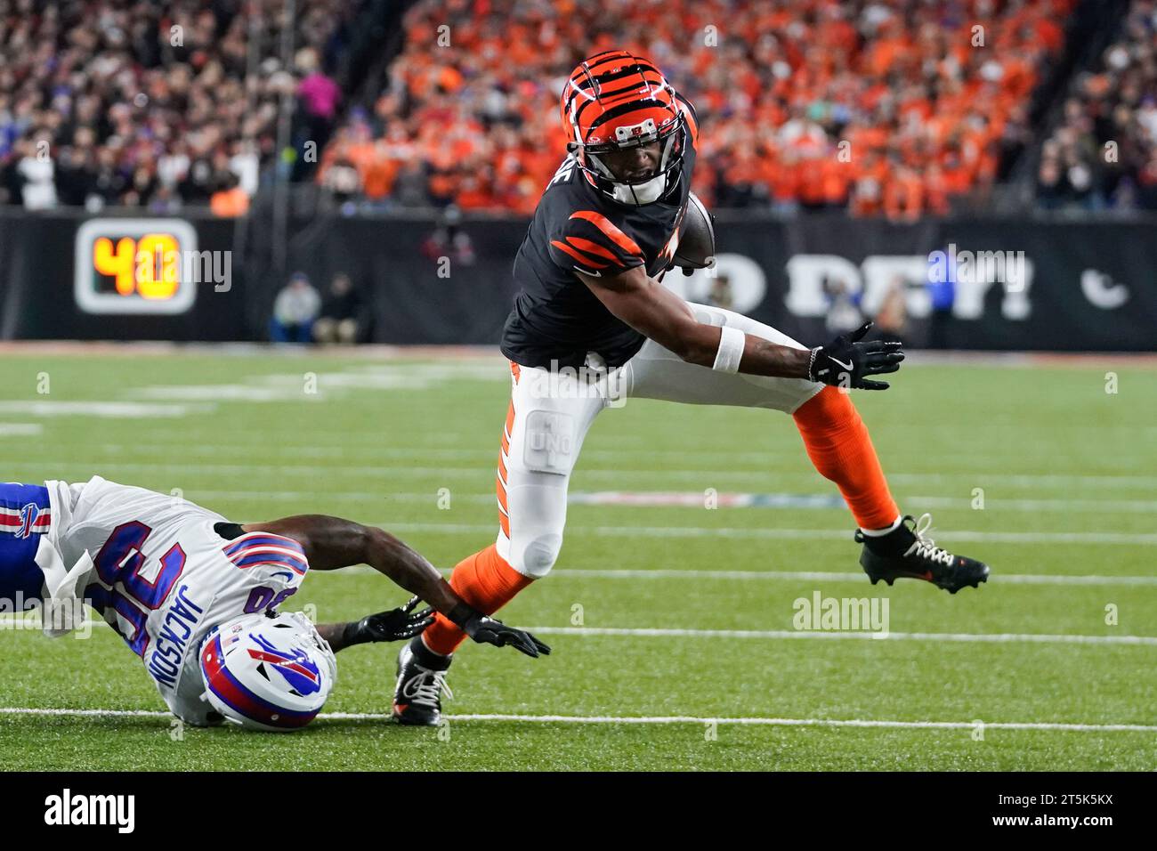 Cincinnati Bengals wide receiver Ja'Marr Chase, right, tries to dodge a ...