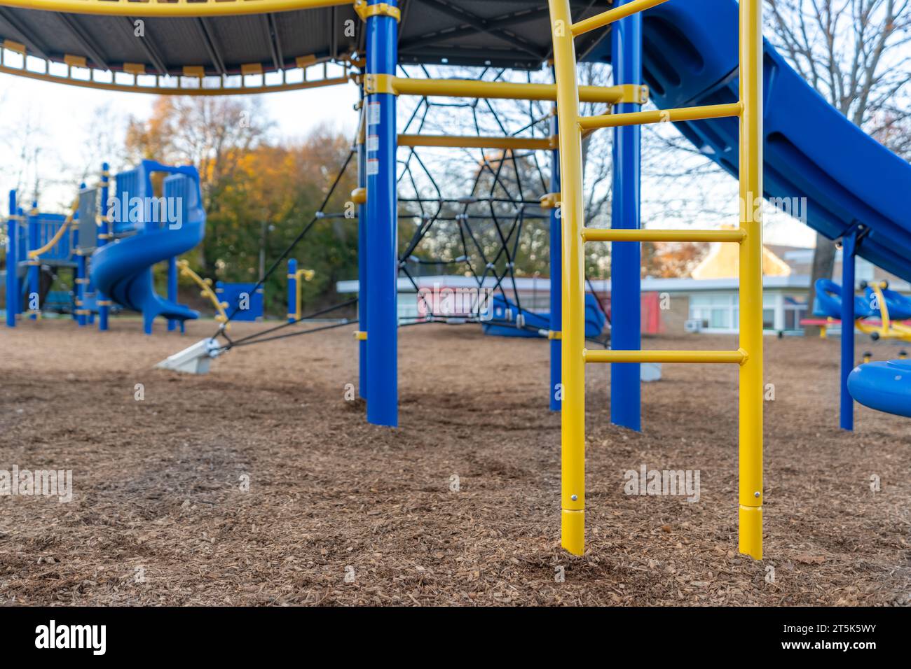 Unidentified typical elementary school playground with engineered wood ...