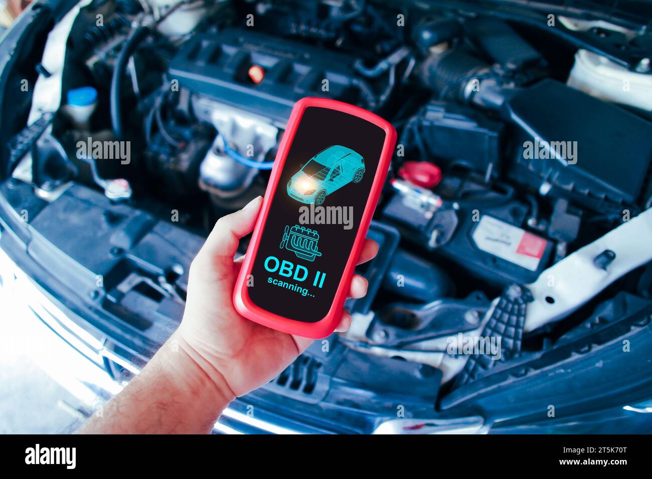 Mechanic man scanning ECU system of car engine by OBD2 wireless scanner ...