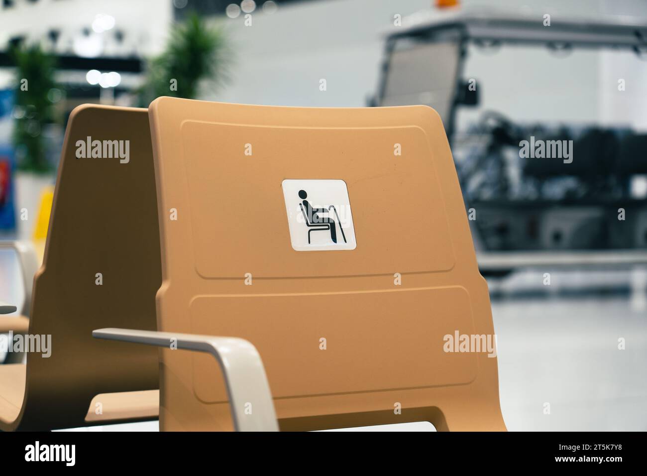 Disable chair seats in a new airport with nobody Stock Photo - Alamy