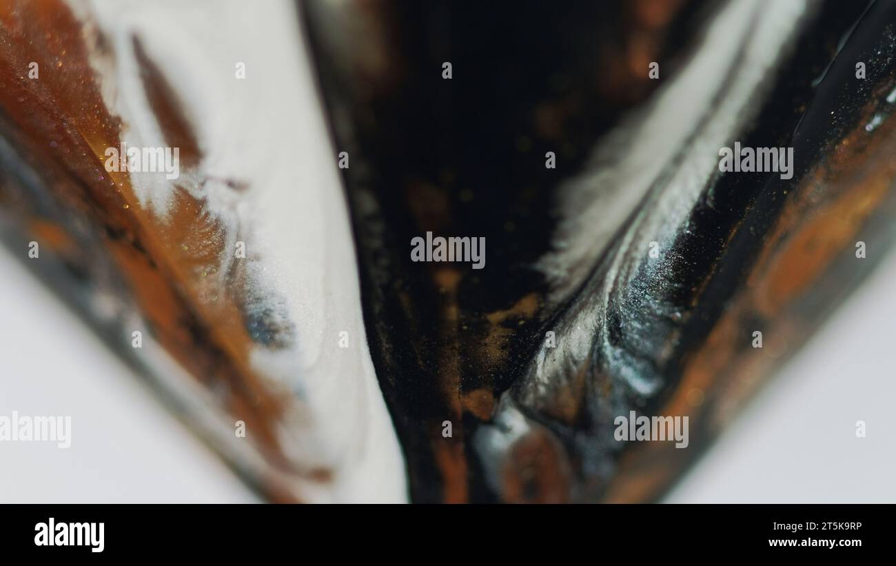 Glitter fluid ink pouring brown marble paint flow Stock Photo - Alamy