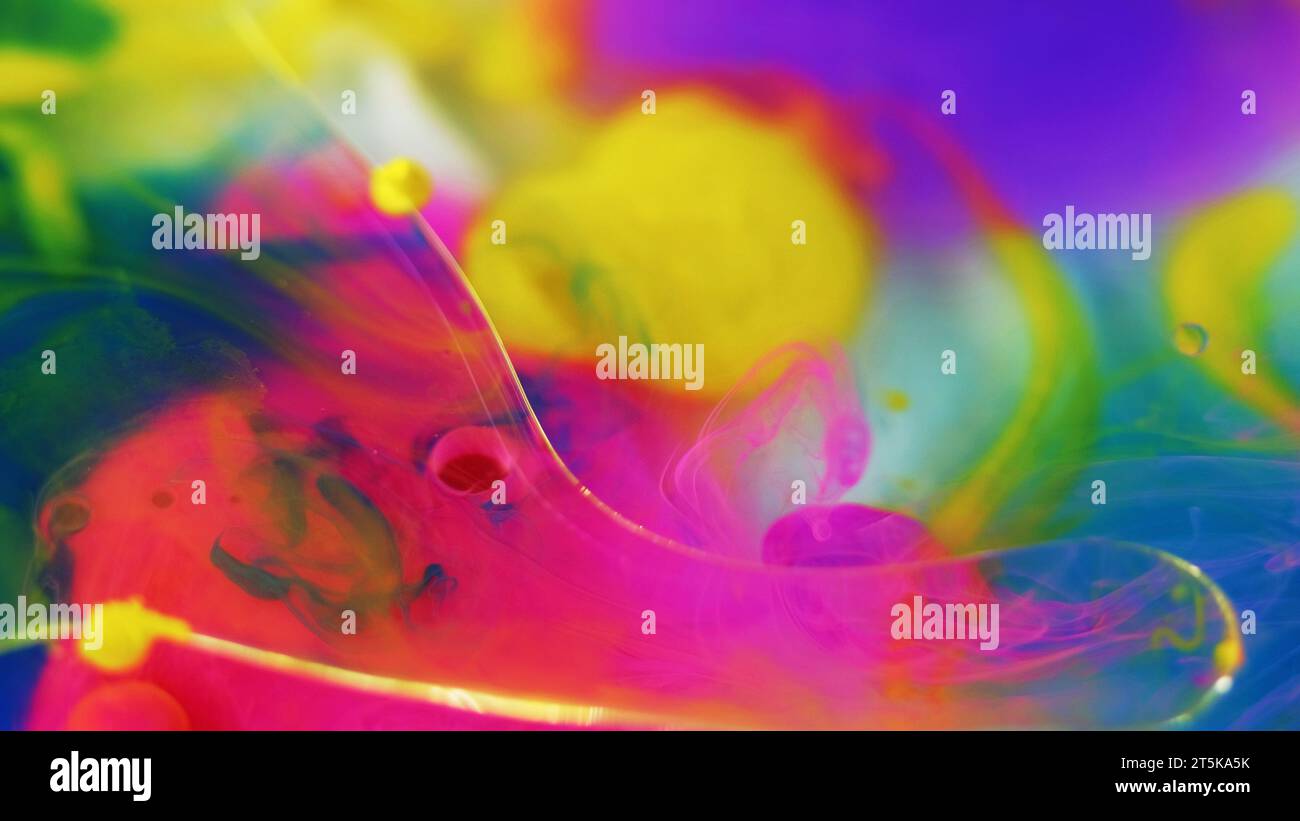 Neon paint water oil drop floating bubble ink mist Stock Photo - Alamy
