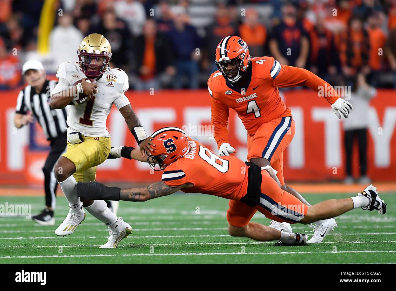 Boston College quarterback Thomas Castellanos, left, avoids pressure ...