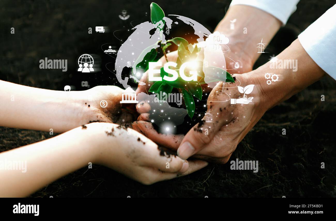 Business partnership leader gather to nurture young seedling plant with ESG icons, symbolizing ...