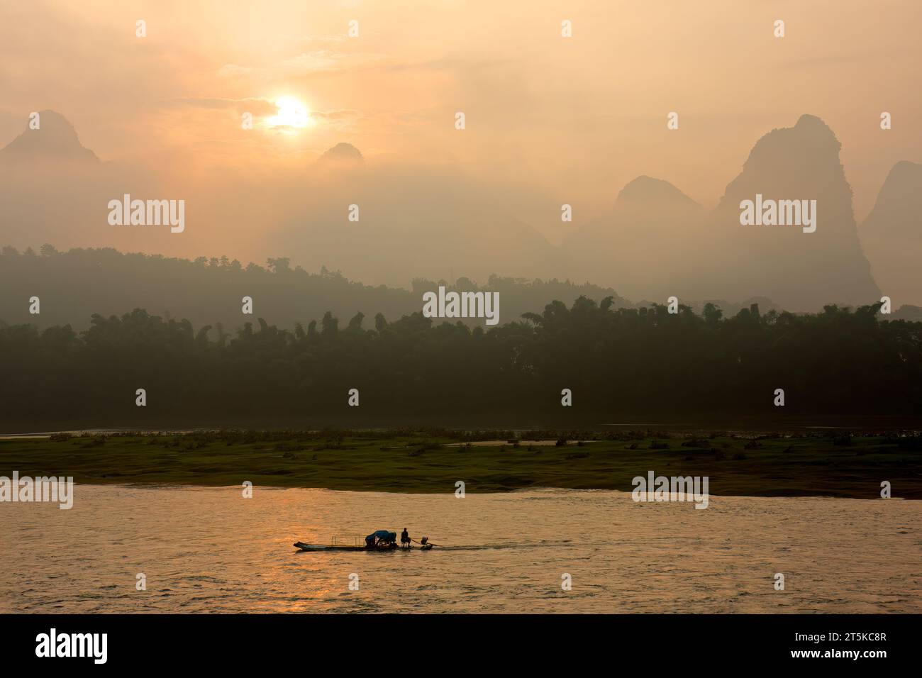 Scenic early morning view over the misty Li-river and limestone hills ...
