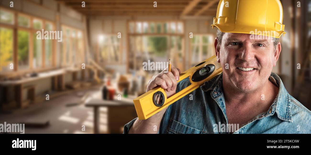 Happy Male Contractor at a Construction Site Wearing a Hard Hat and ...