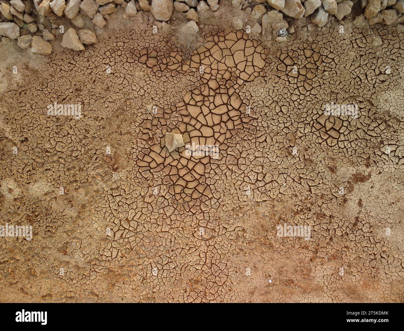 Aerial top down view on dry cracked red soil. arid, cracked red soil ...