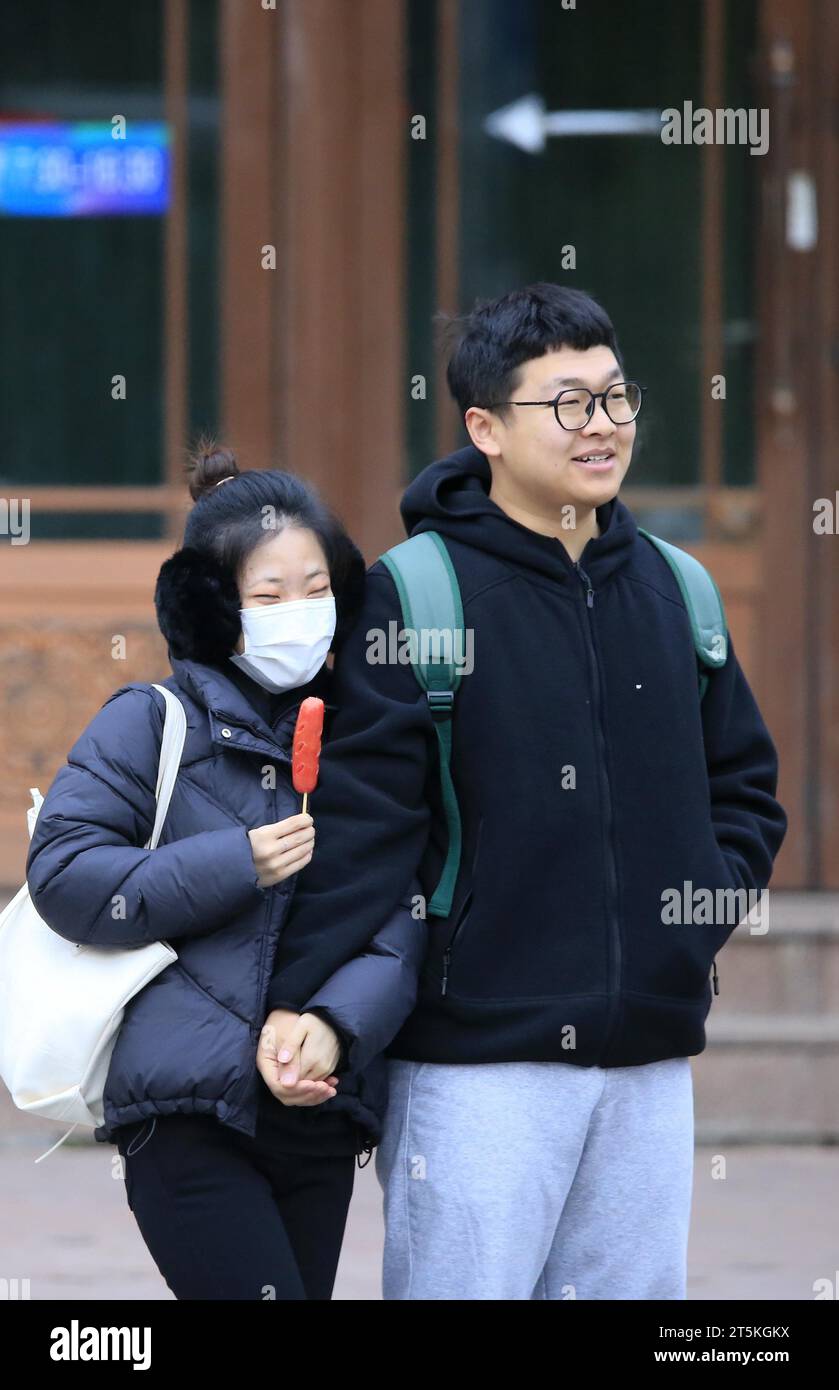 People wear thick clothes as the temperature drops sharply in Harbin ...
