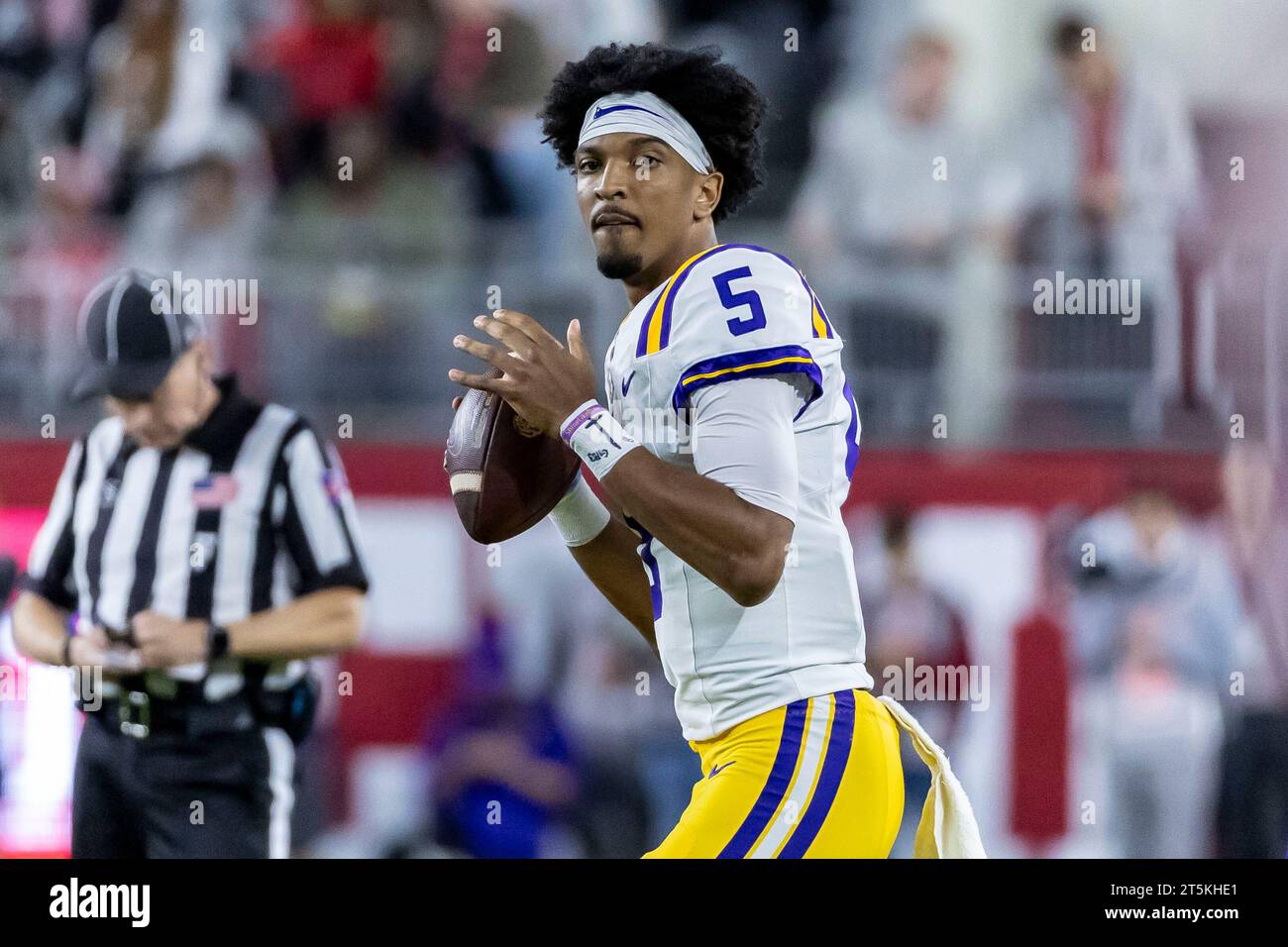LSU quarterback Jayden Daniels (5) warms up during a timeout in the ...