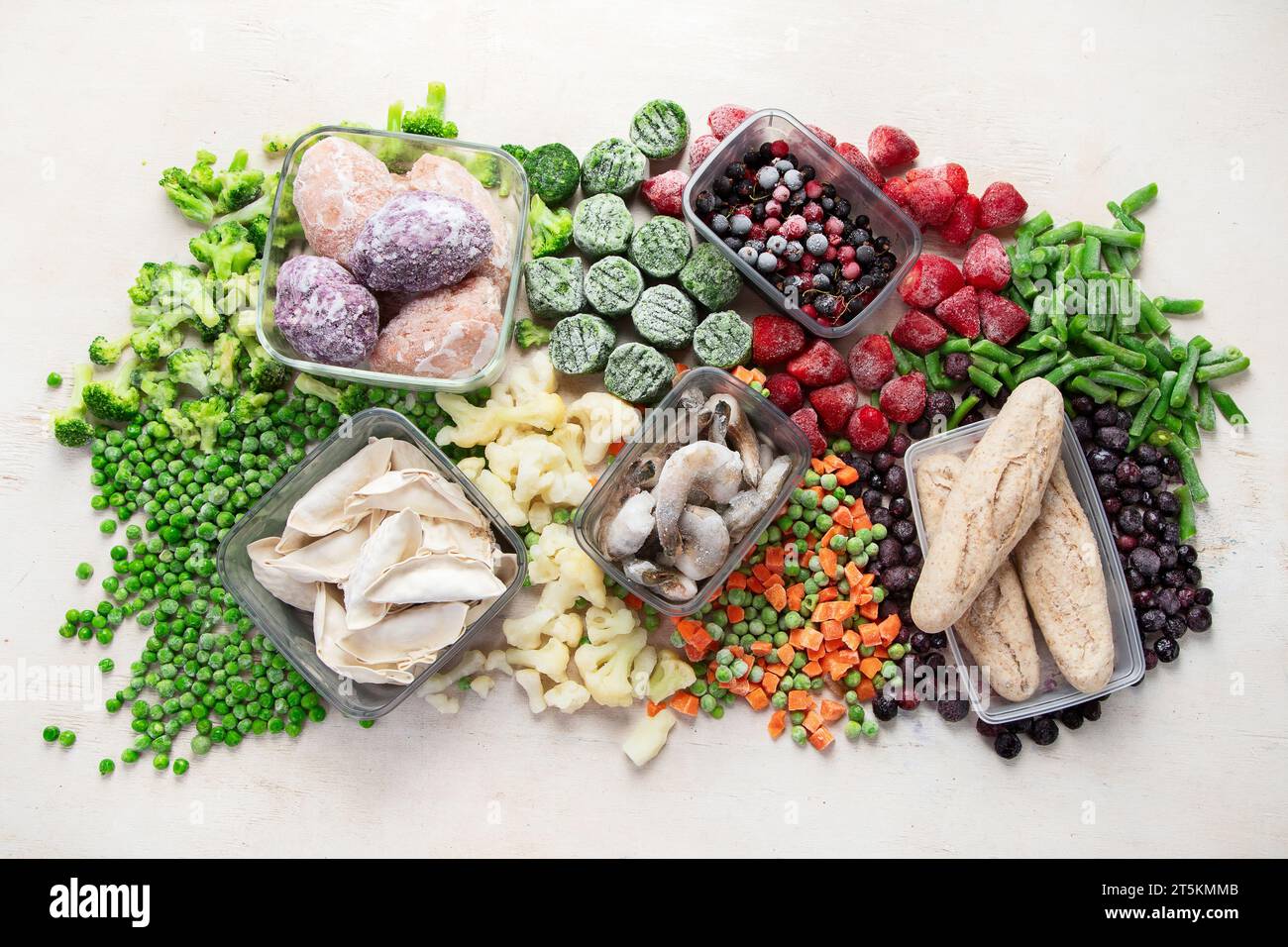 Frozen food, vegetables, fruits, meat, bread and fish on a white ...