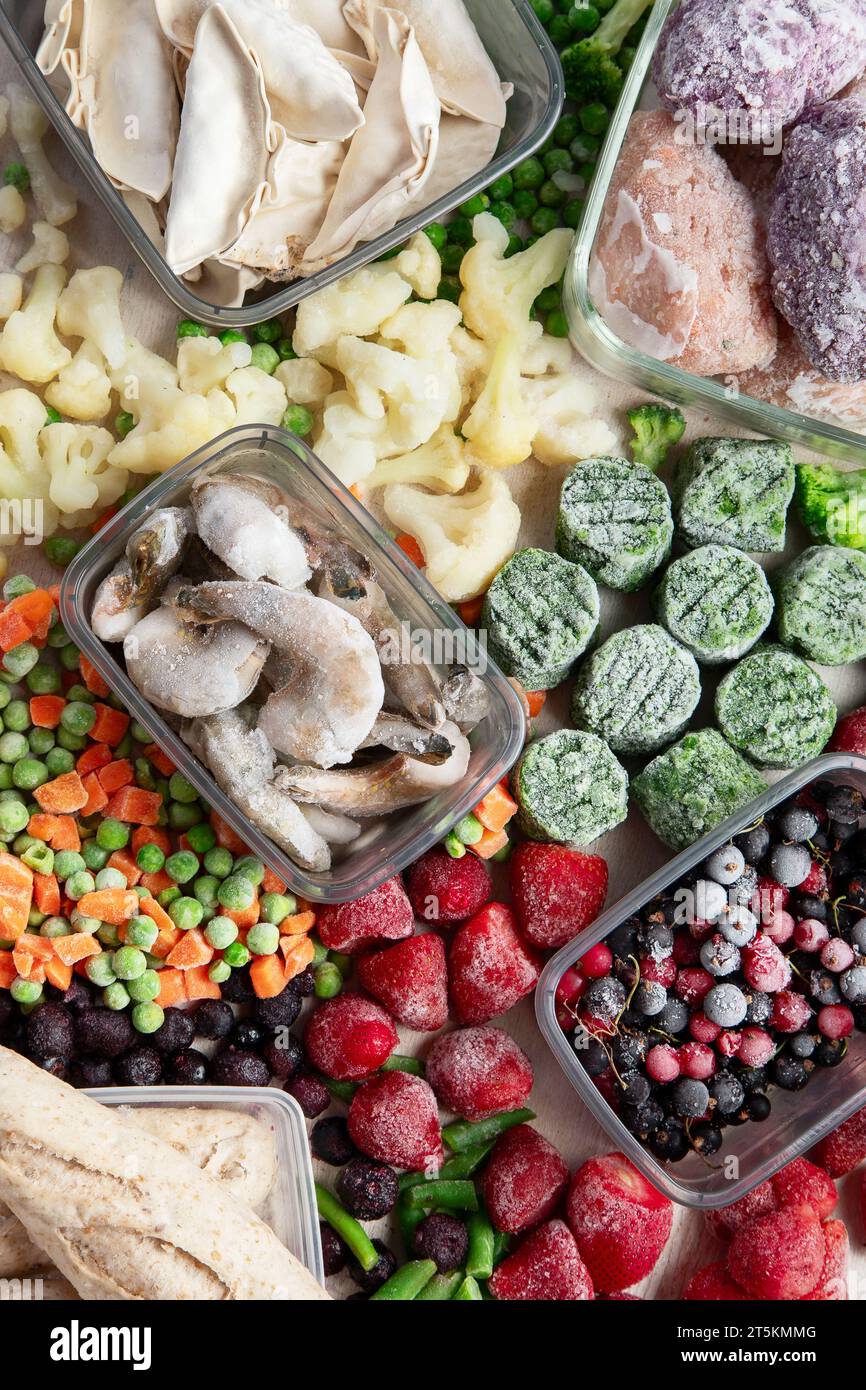 Frozen food, vegetables, fruits, meat, bread and fish on a white ...