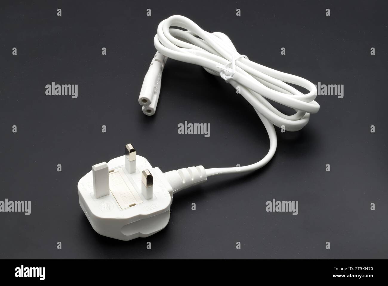 UK type power cable isolated on black background Stock Photo - Alamy