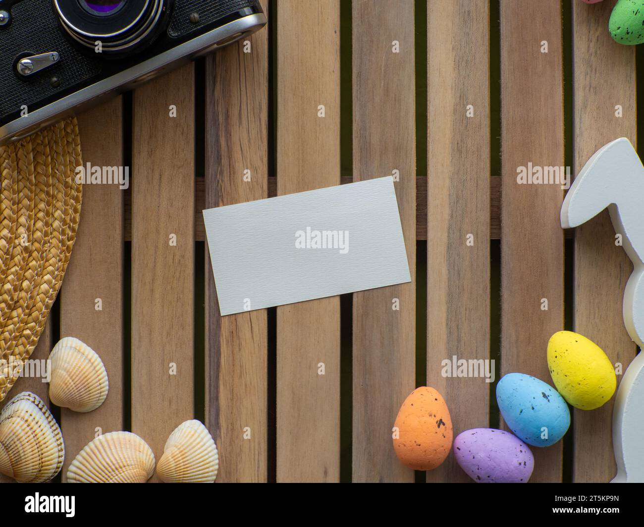 Easter background with straw hat, photo camera, colorful eggs and white ...