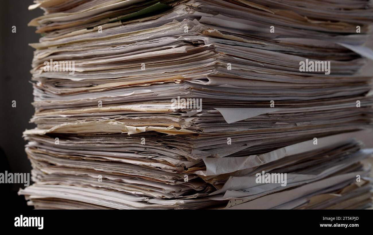 Stack business paper on desk, paperwork in office. Piled heap high ...