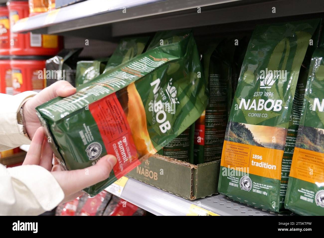 Woman buying Nabob 100 percent Colombian summit coffee inside a Walmart ...