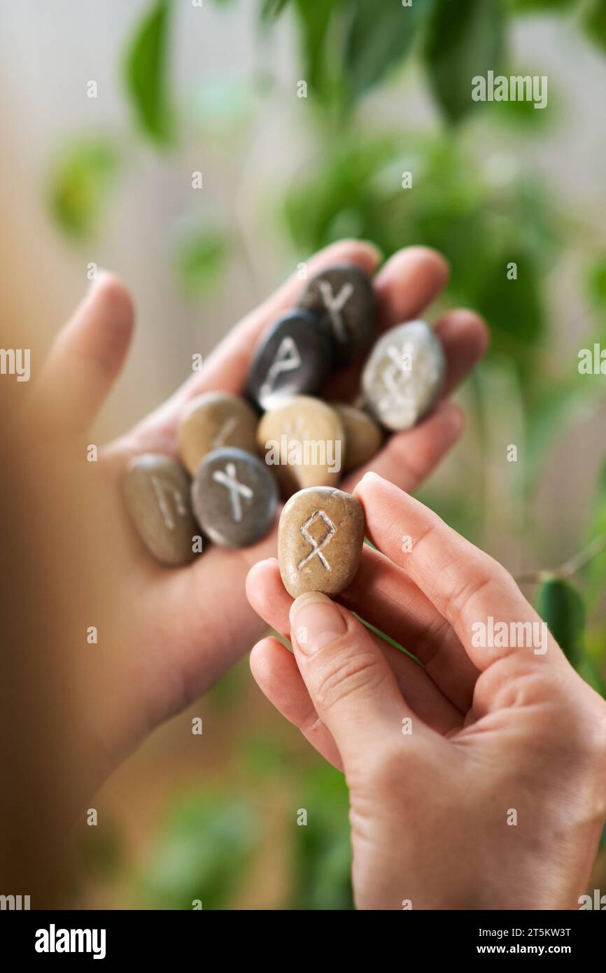 stone runes in a woman's hand Stock Photo - Alamy
