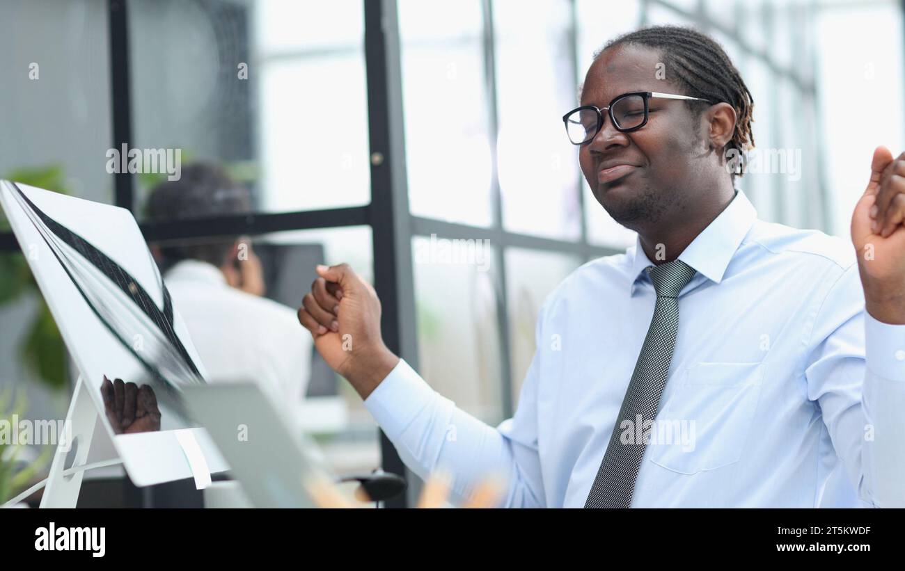 happy man working in the office. raised his hands joyfully Stock Photo ...
