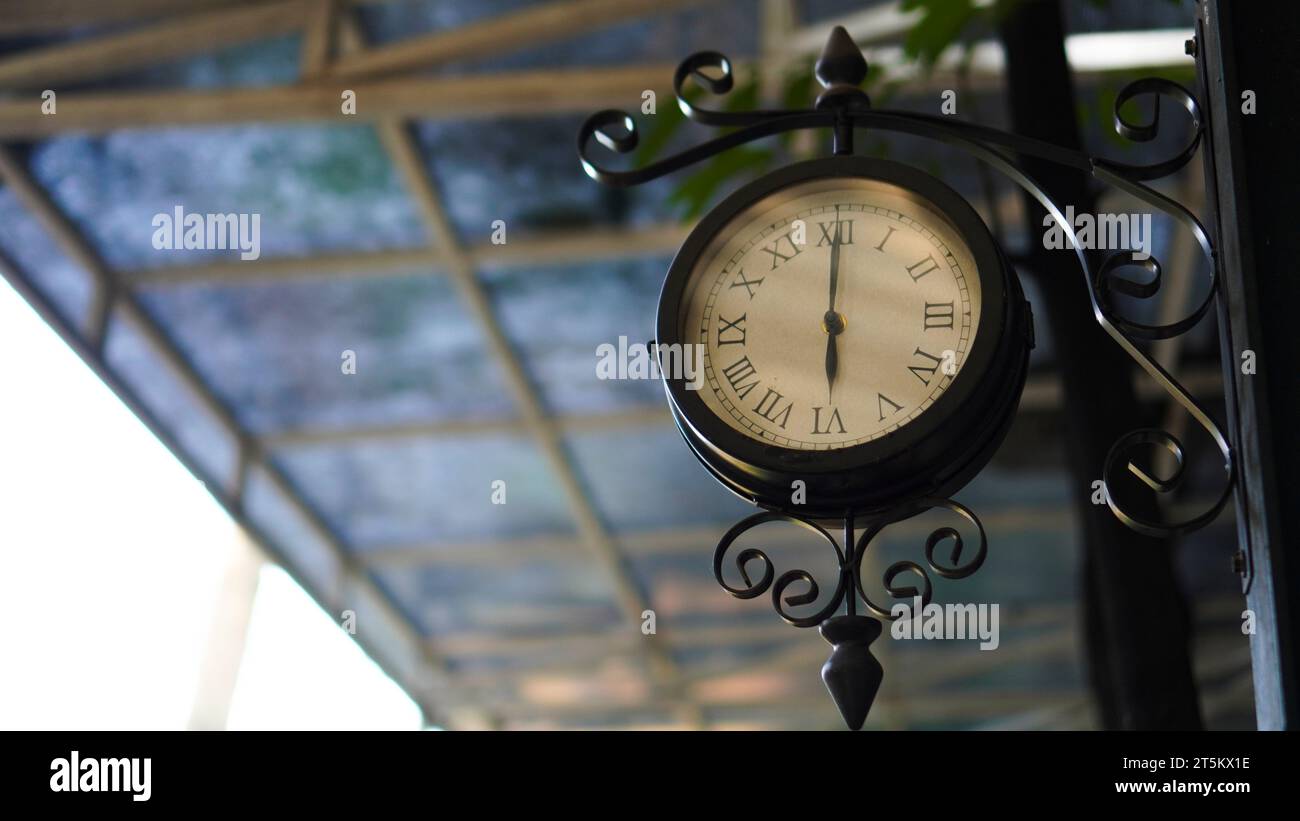 Vintage street clock on a iron pole shot in hing angle view Stock Photo ...