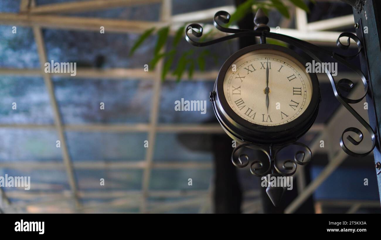 Vintage street clock on a iron pole shot in hing angle view Stock Photo ...