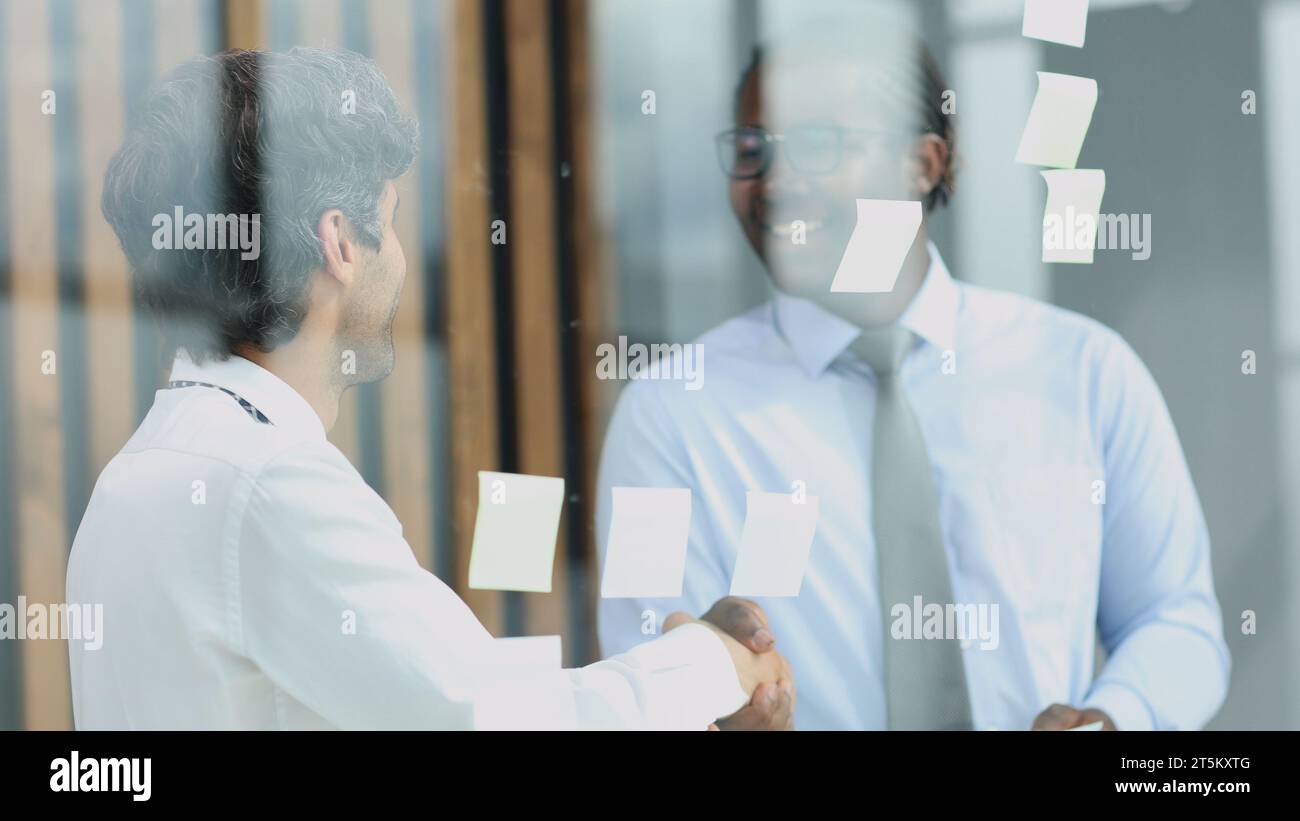 Young man standing behind board hi-res stock photography and images - Alamy