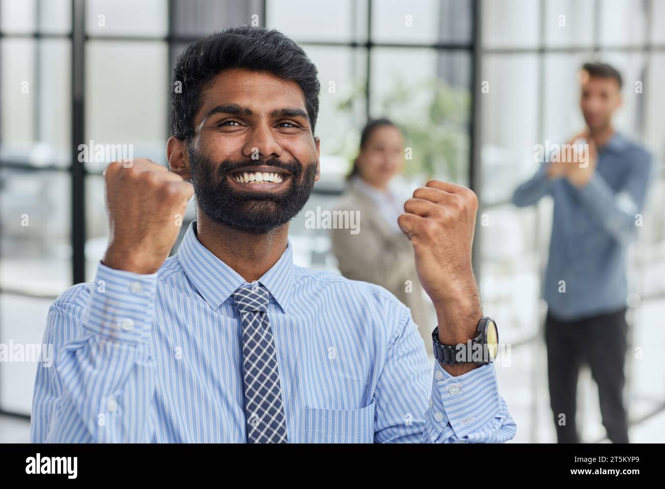 a man holding his hand up a gesture of triumph and victory Stock Photo ...