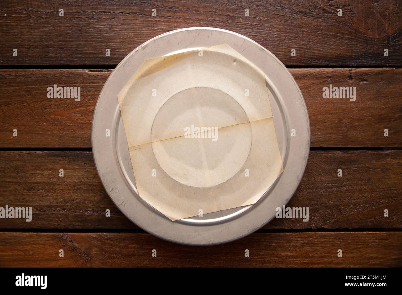 Old cinema film reel box on a rustic vintage wooden board. Blank label ...