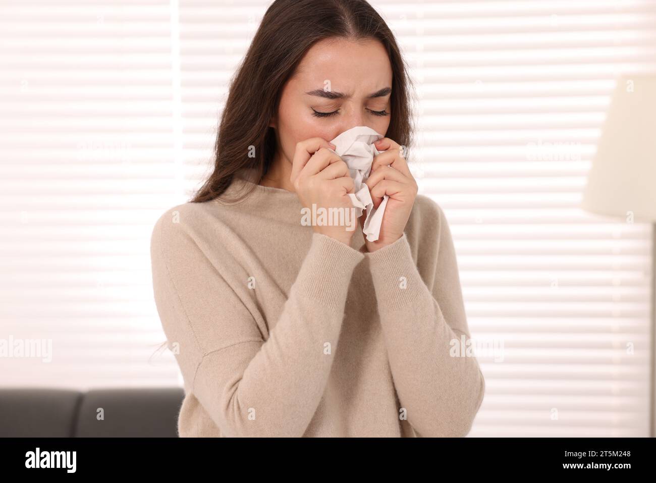 Sick woman sneezing tissue home hi-res stock photography and images - Alamy
