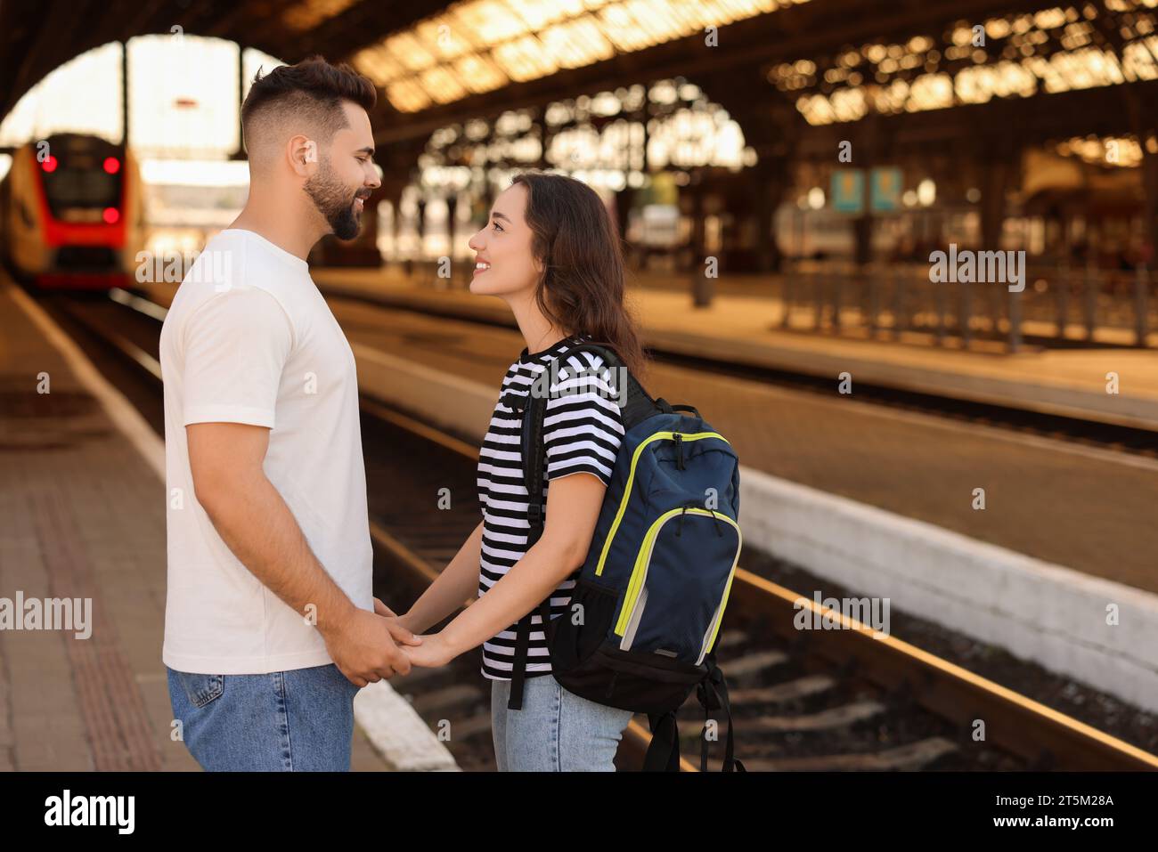 Long-distance relationship. Beautiful couple on platform of railway ...