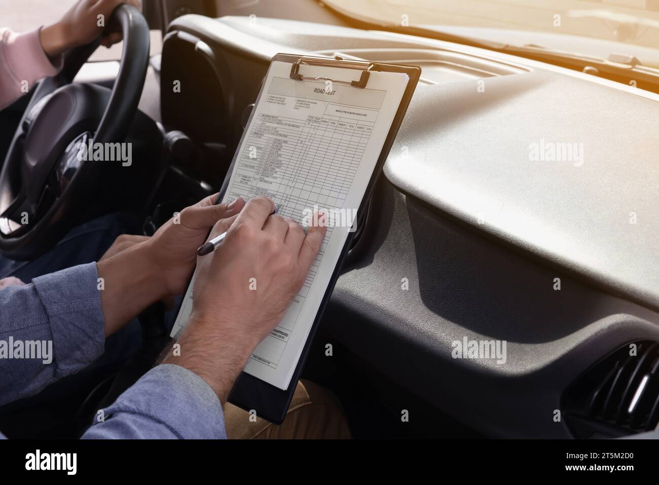 Driving school. Student passing driving test with examiner in car ...