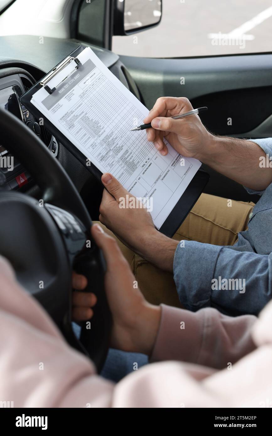 Driving school. Student passing driving test with examiner in car ...