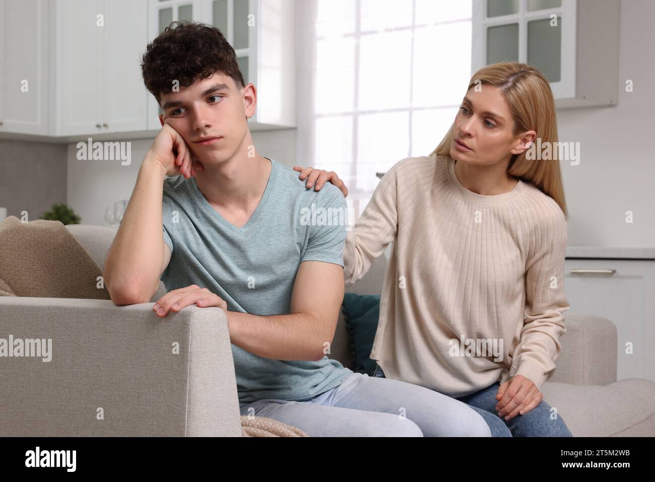 Mother consoling her upset son at home. Teenager problems Stock Photo ...