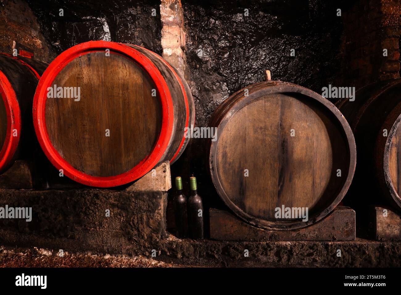 Wooden barrels with alcohol drinks in cellar Stock Photo - Alamy