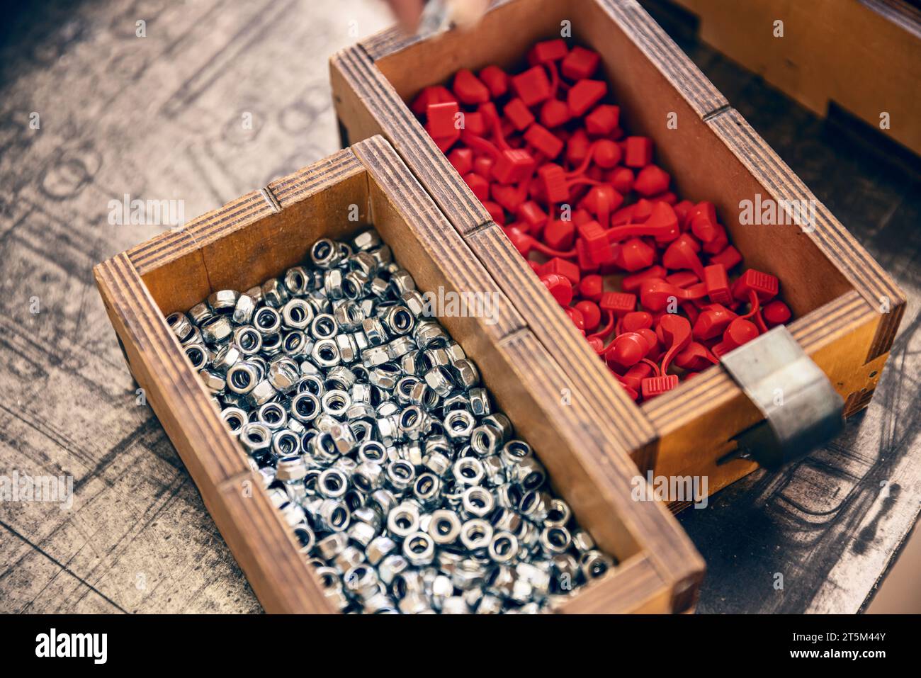 Metal nut with metric thread in wooden box. Metal accessories for ...