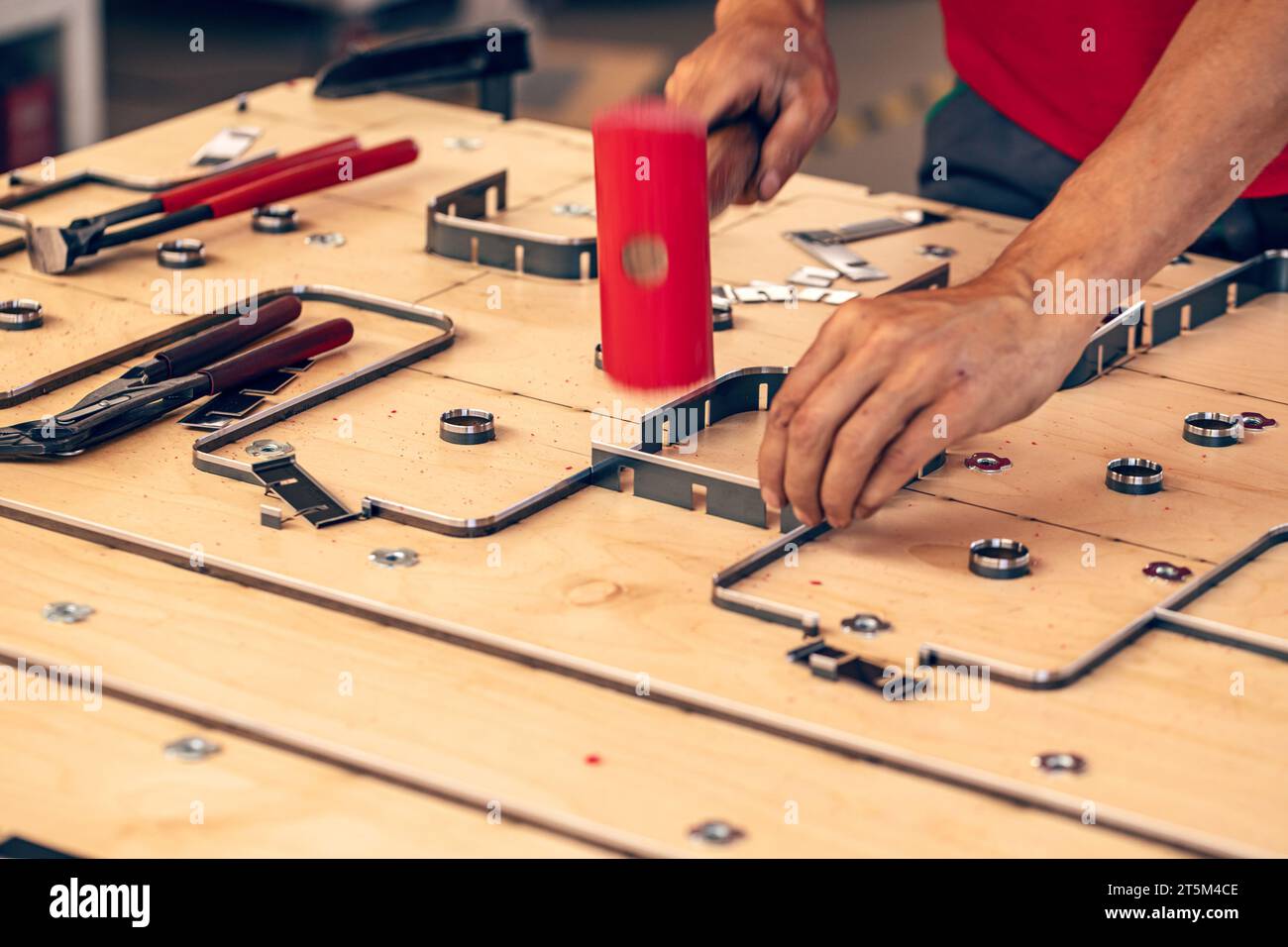 Professional male master using hammer while making creative patterns ...