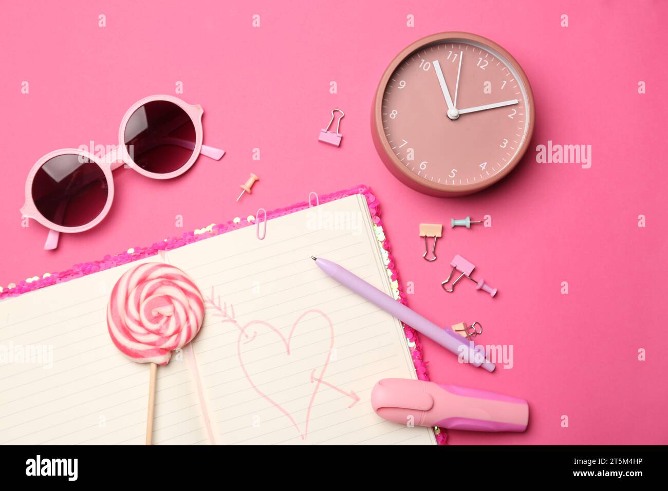 Flat lay composition with heart drawn in notebook on pink background ...