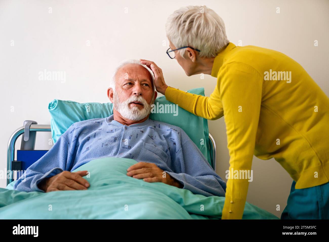 Senior woman with seriously ill husband in hospital. Healthcare support ...