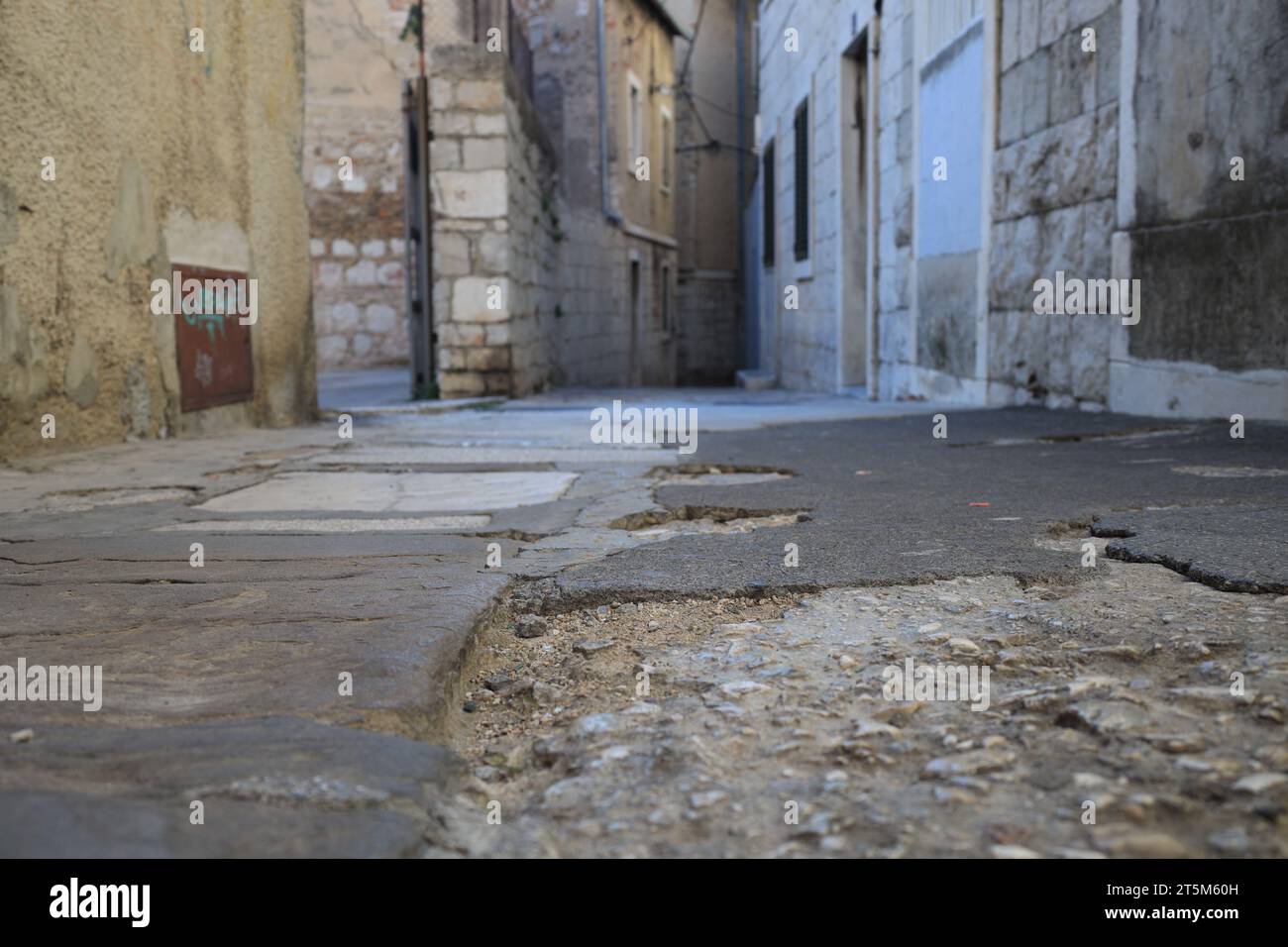 Empty asphalted alleyway between residential buildings in town Stock ...