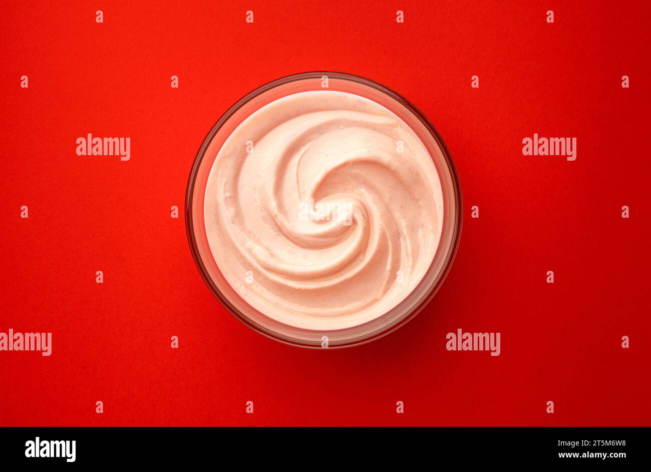 Bowl of strawberry yogurt on red background, top view Stock Photo - Alamy