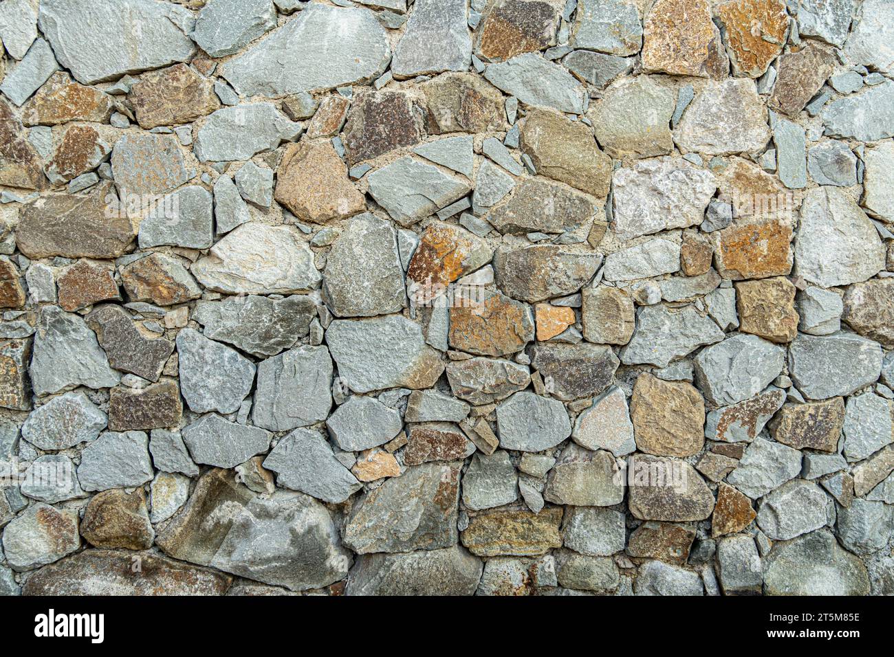 Stone wall texture with cracks and small holes attracts tourists ...