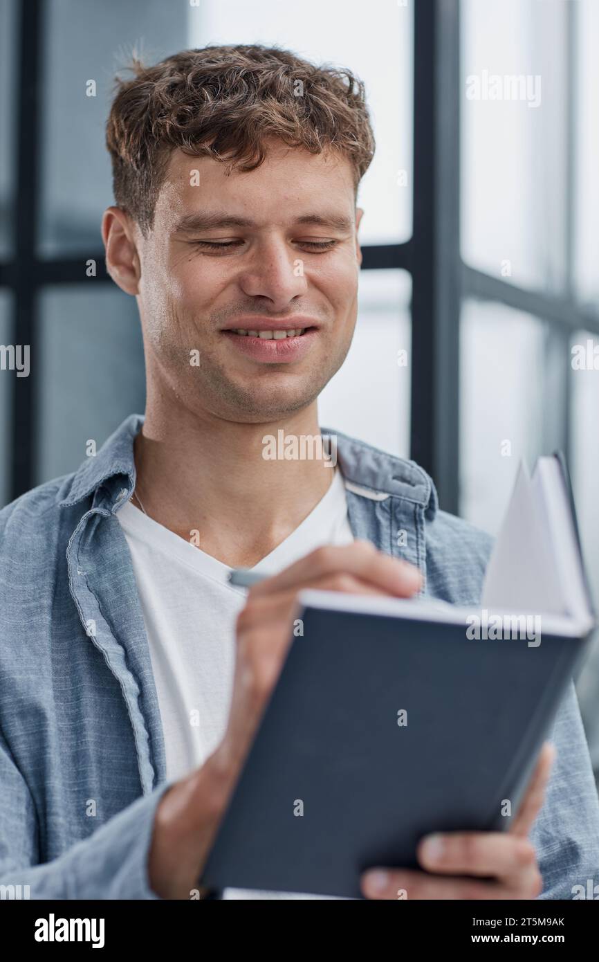 Attractive student guy making notes hi-res stock photography and images ...