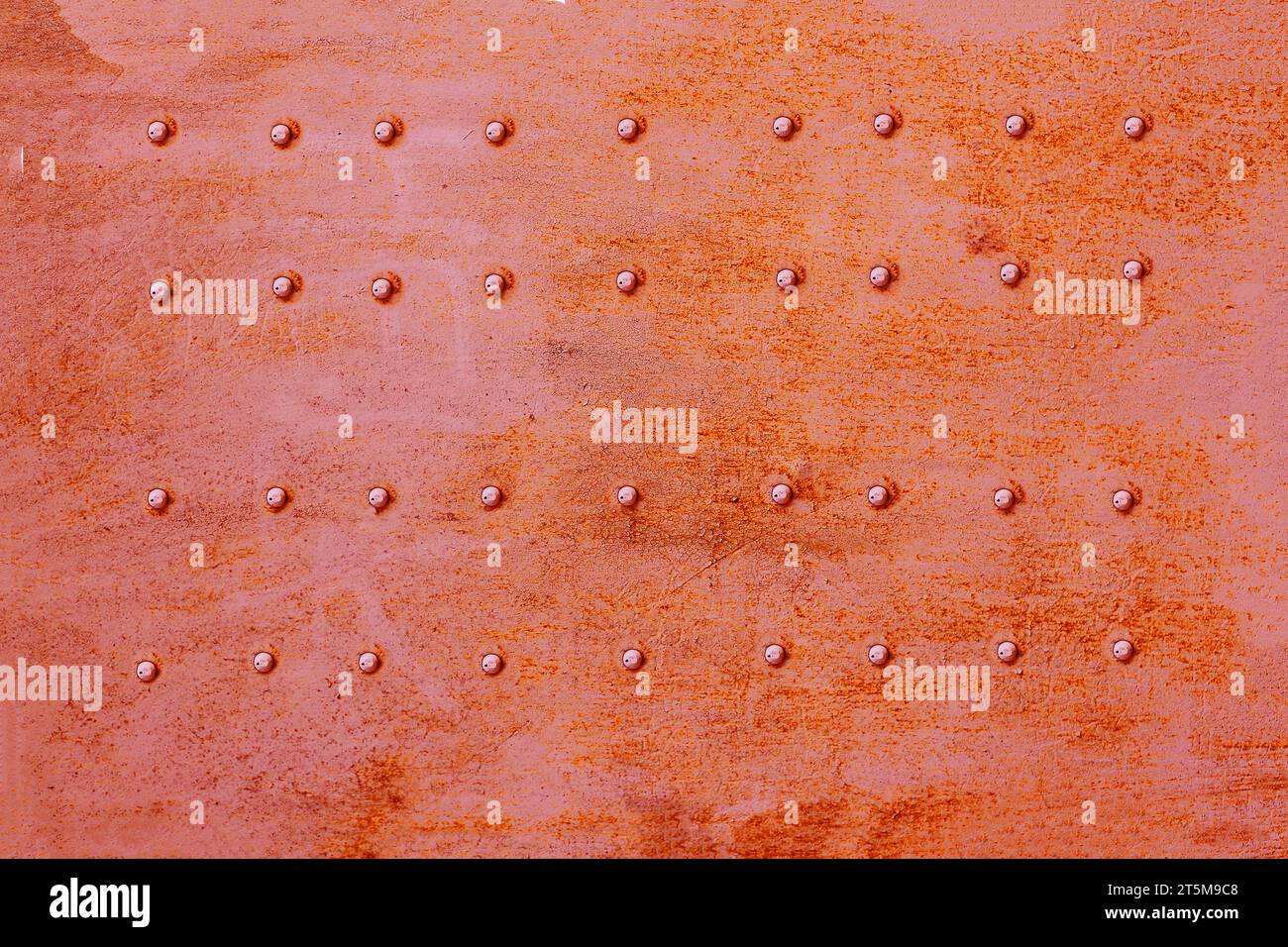 Riveted metal surface, painted red Stock Photo - Alamy