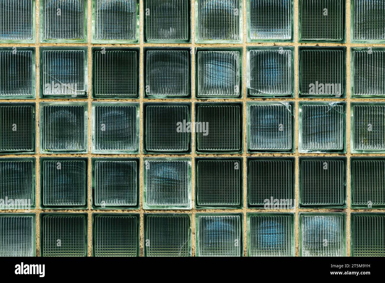 Old solid glass block brick wall pattern as background Stock Photo - Alamy