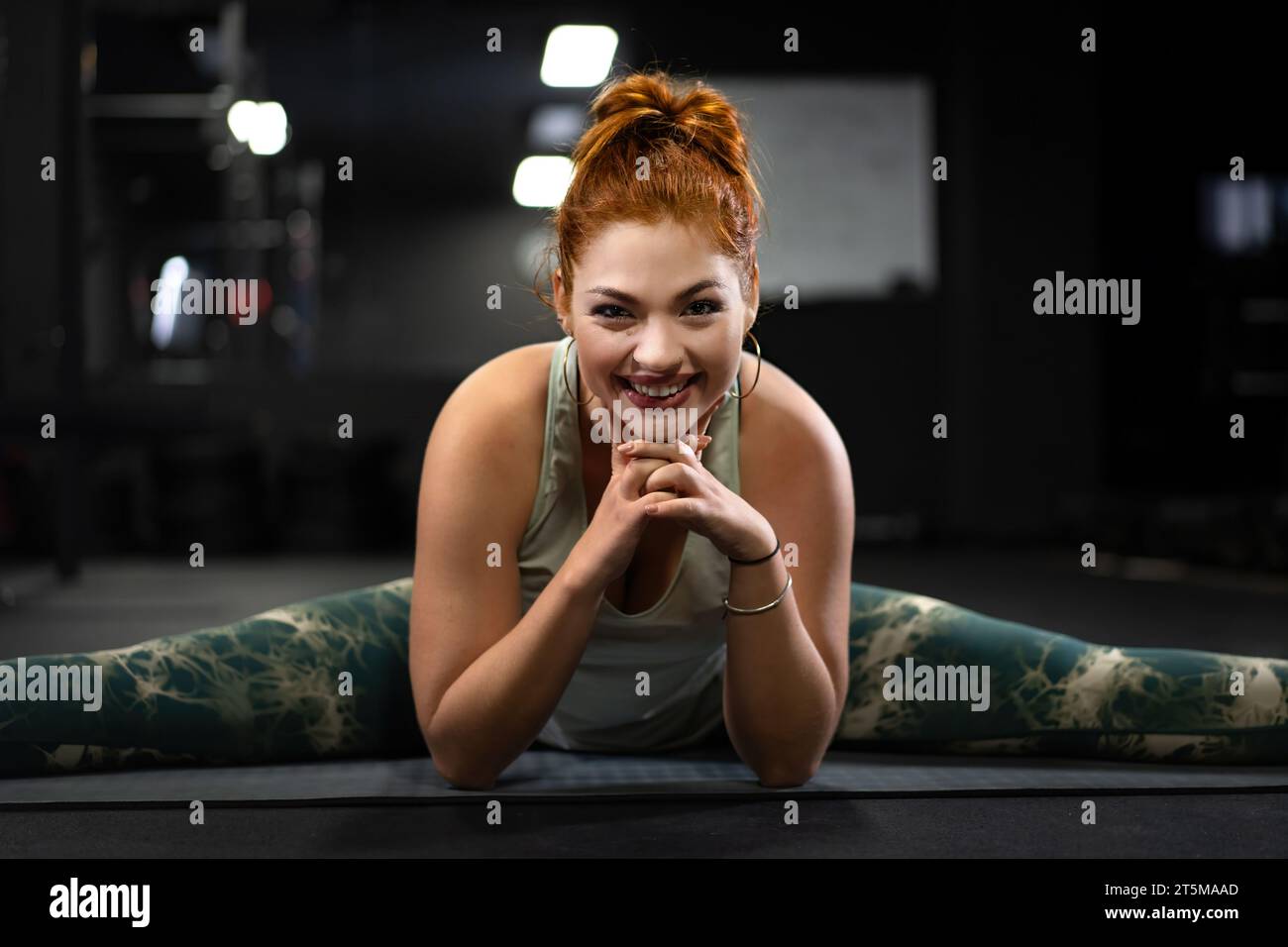A young woman with a beaming smile exhibits the joy of staying active ...