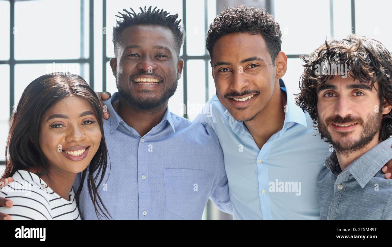 Cheerful group of people smiling and working together indoors Stock ...