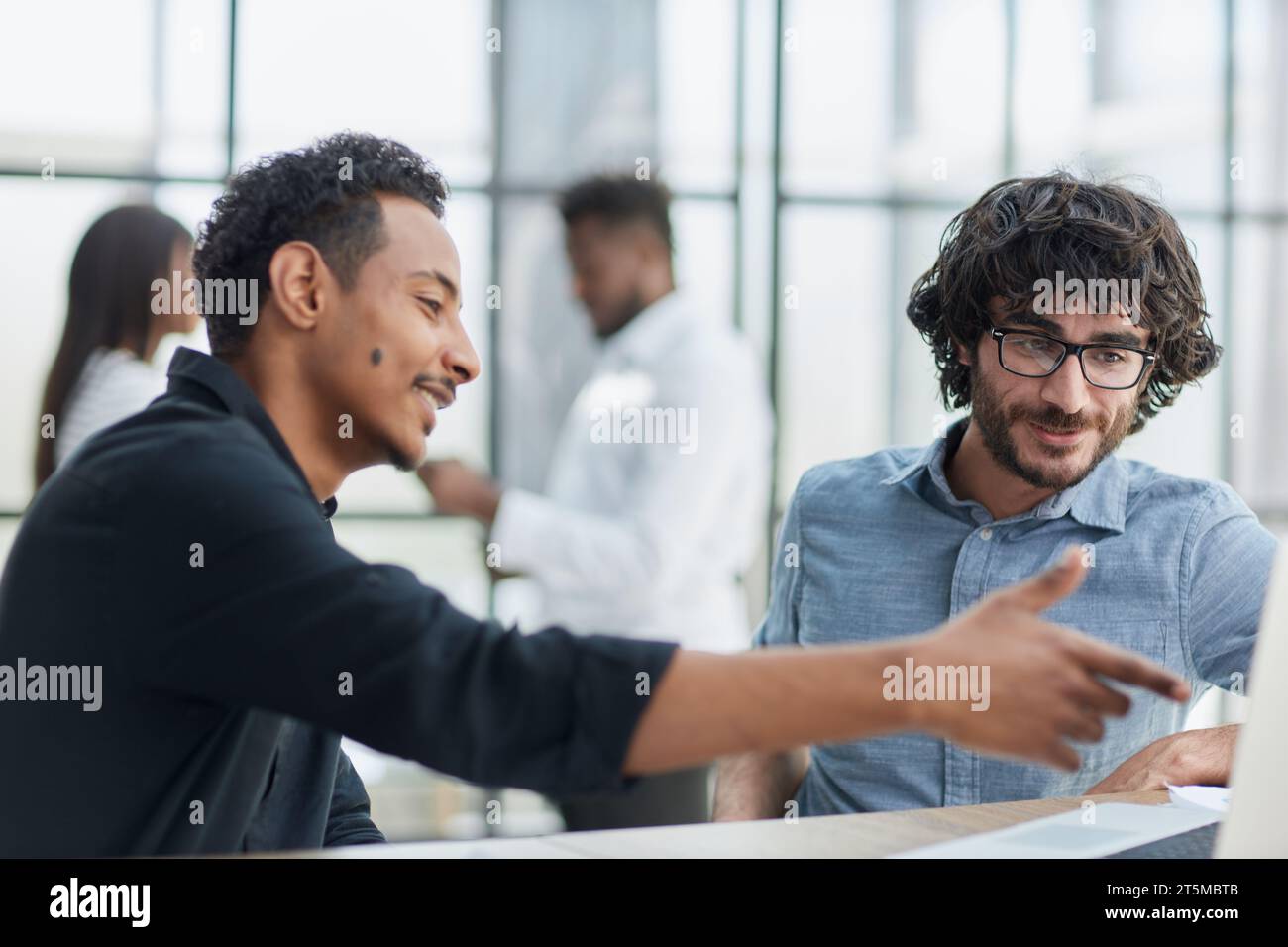 Business professionals in a meeting, collaborating, communicating, and ...