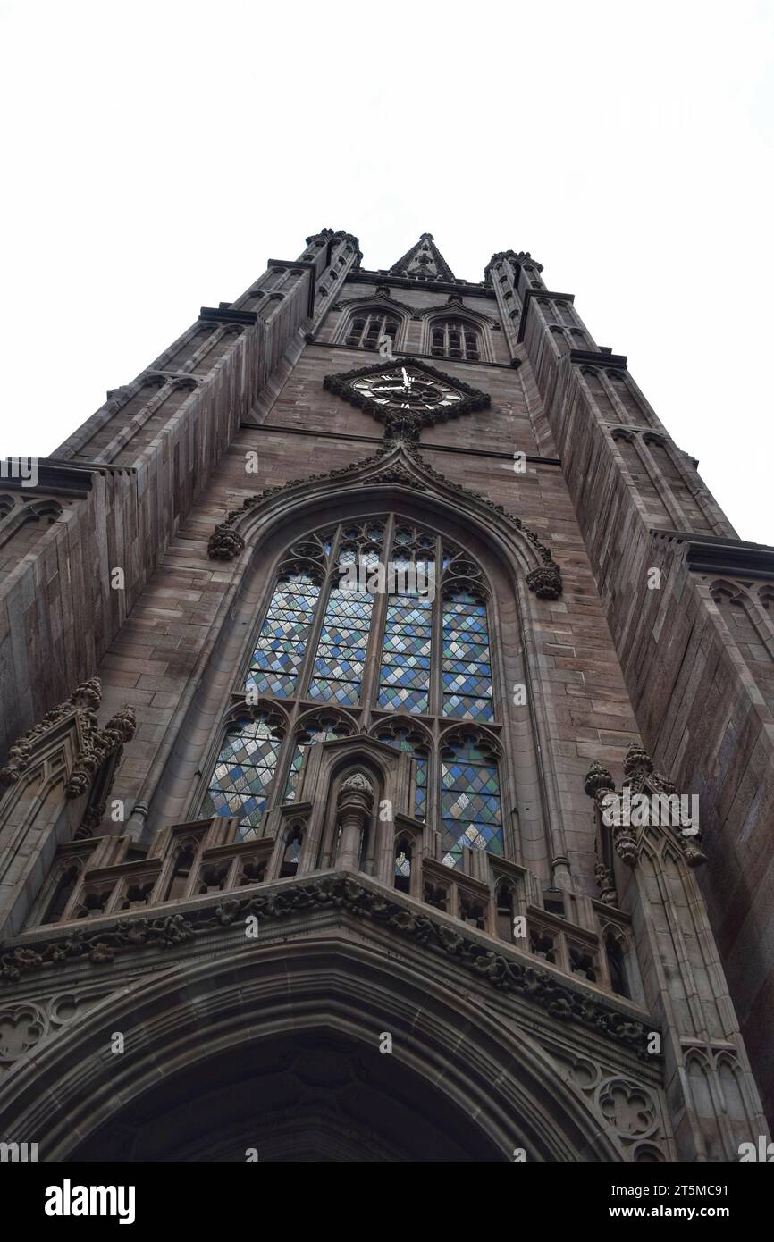 An iconic old clock building stands tall, surrounded by modern ...
