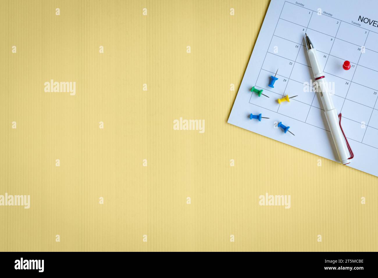 Calendar with colorful pins and pen, top view. Copy space Stock Photo ...