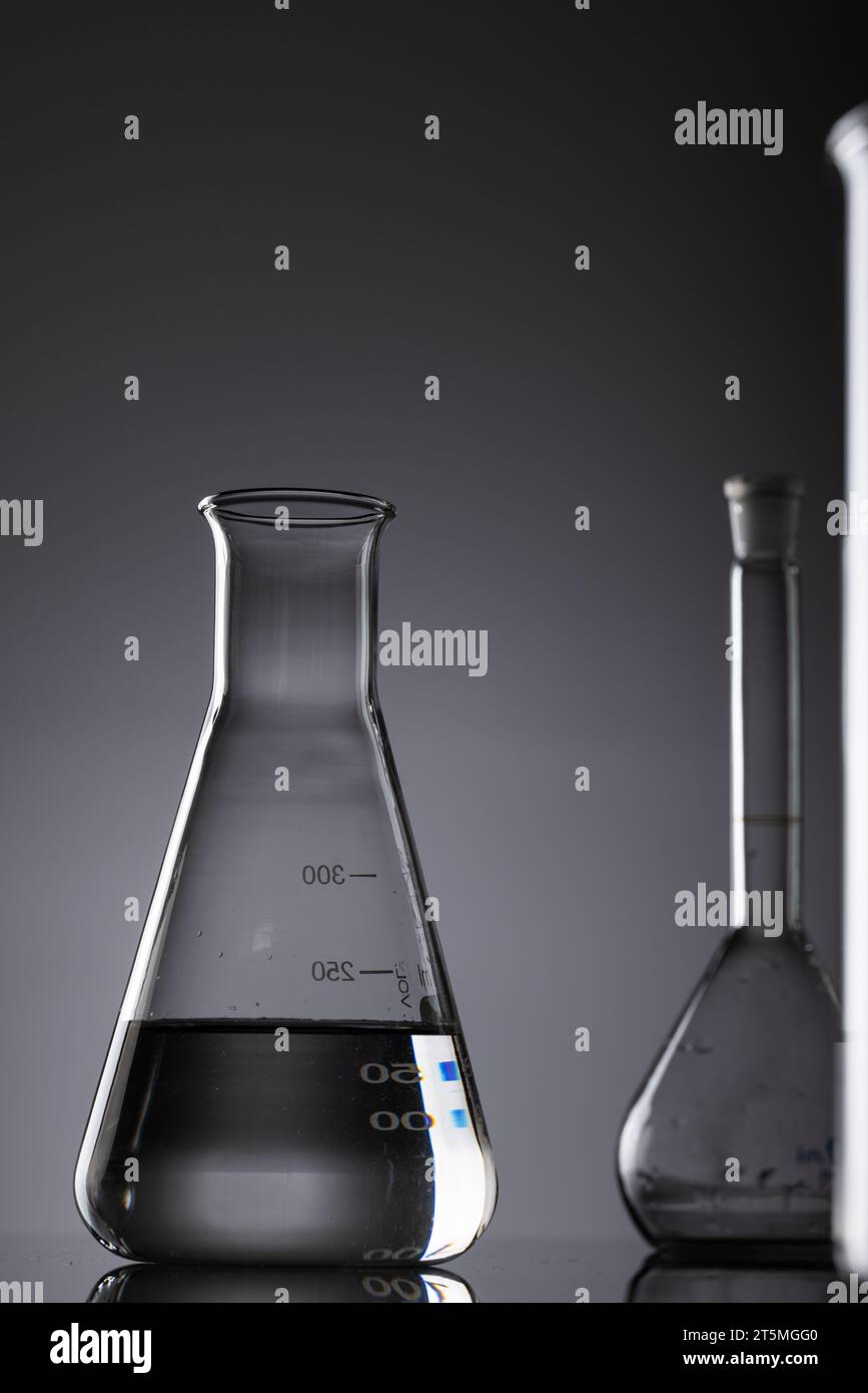 Vertical image of close up of laboratory dishes and copy space on grey ...