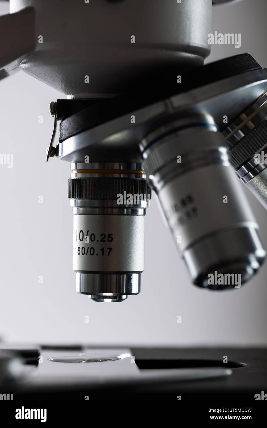 Vertical image of laboratory microscope and copy space on grey ...