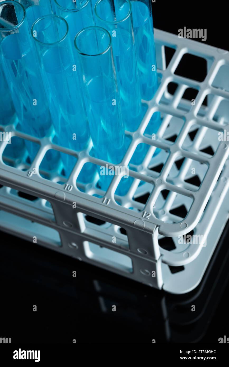 Close up of laboratory test tubes with blue liquid and copy space on ...